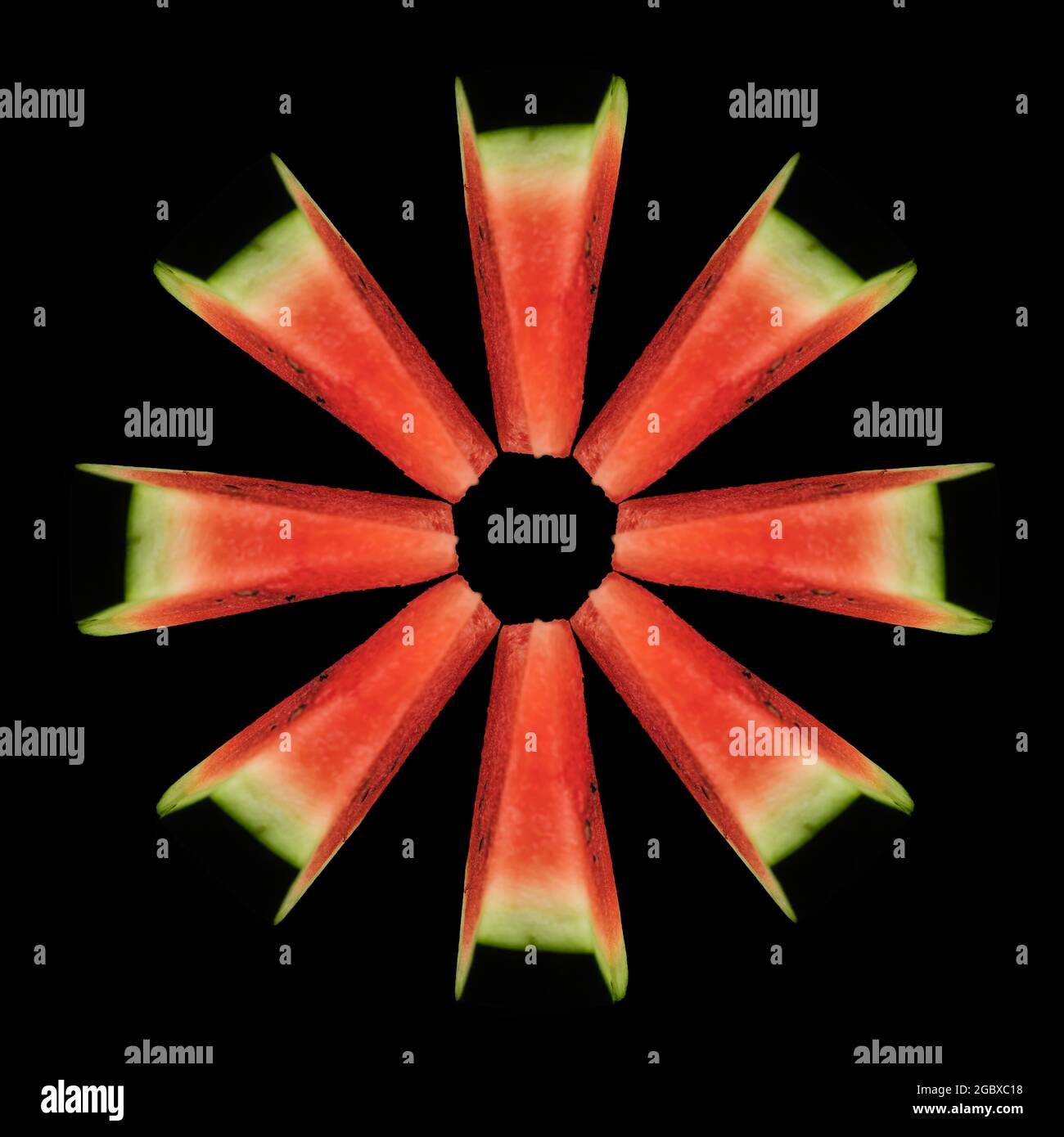 Watermelon cut into equal parts, set in the shape of a circle, on a ...