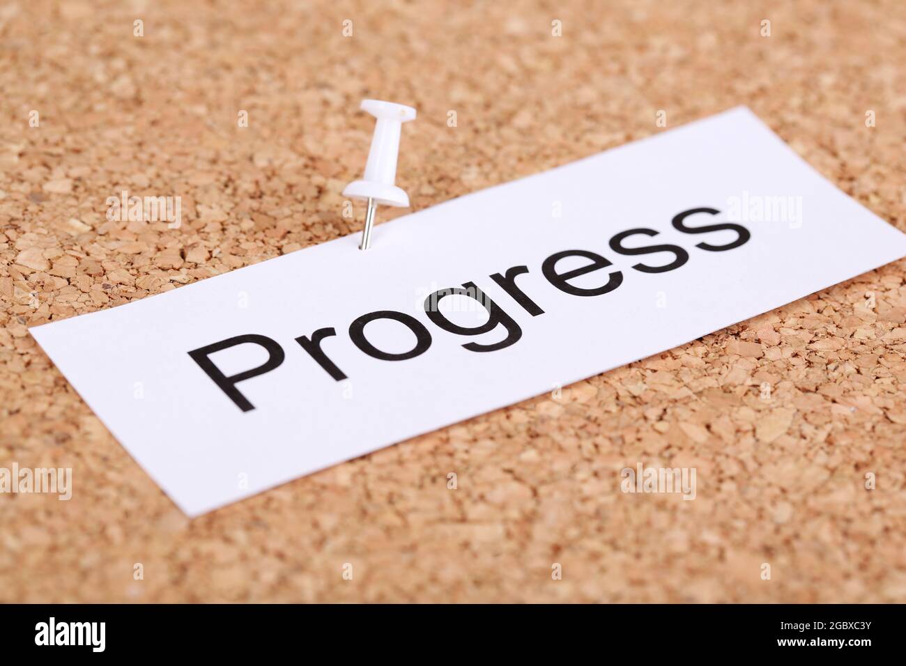 Push pin on paper with word progress on cork board Stock Photo - Alamy