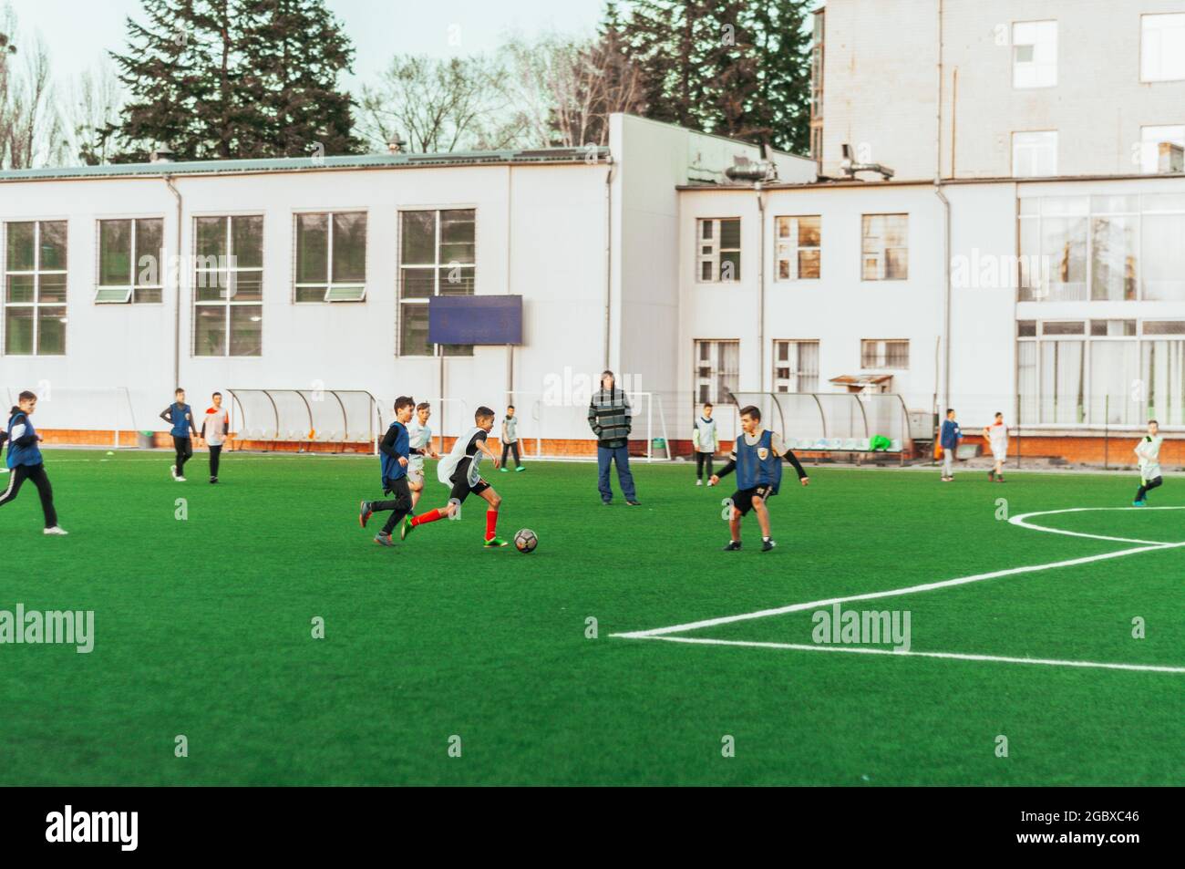 Group of children is playing football on a field Stock Photo - Alamy
