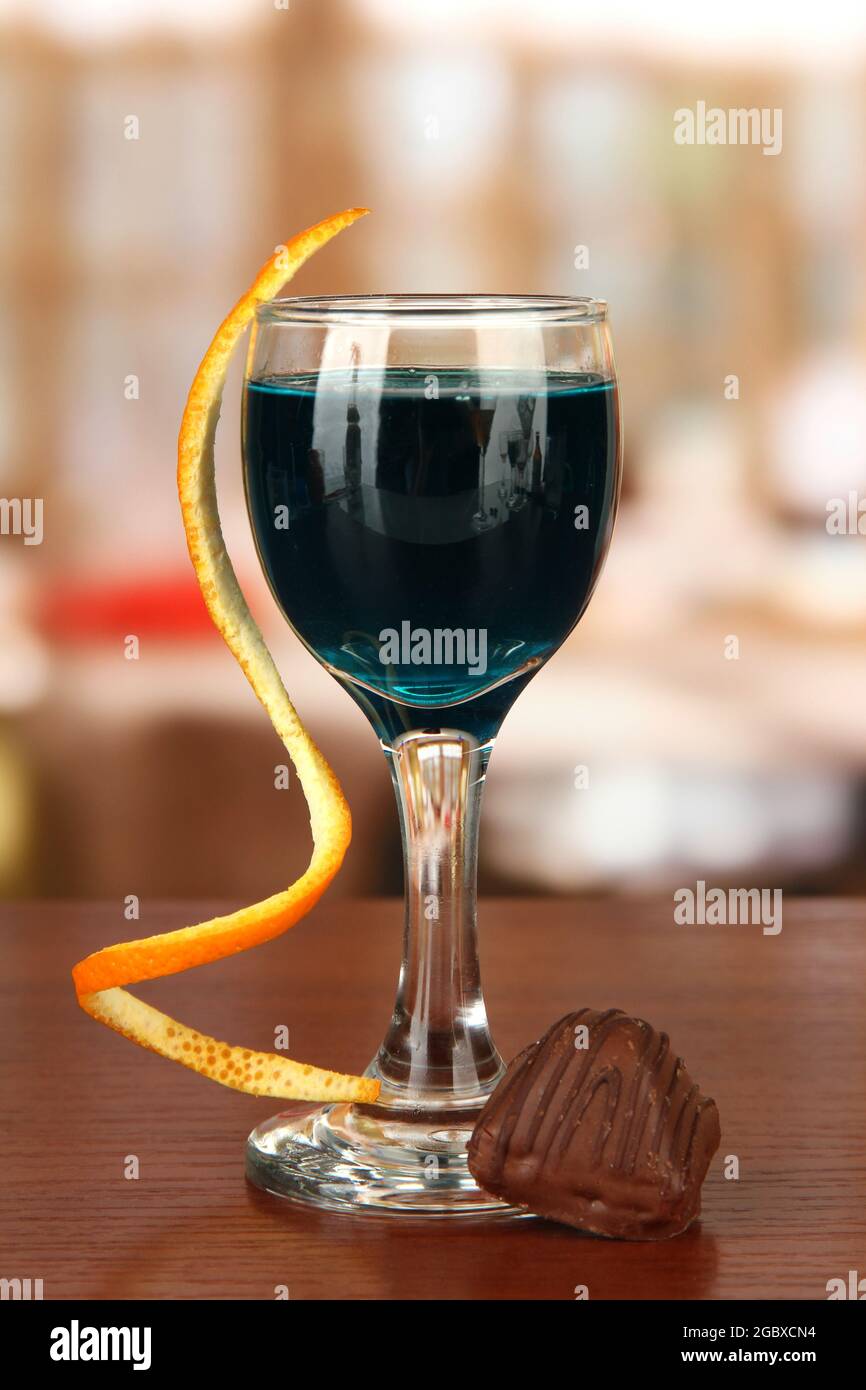 Tasty color liquor, on bright background Stock Photo - Alamy