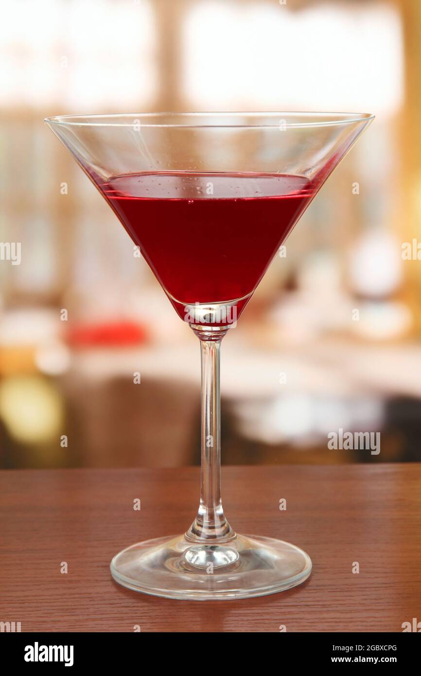 Tasty color liquor, on bright background Stock Photo - Alamy