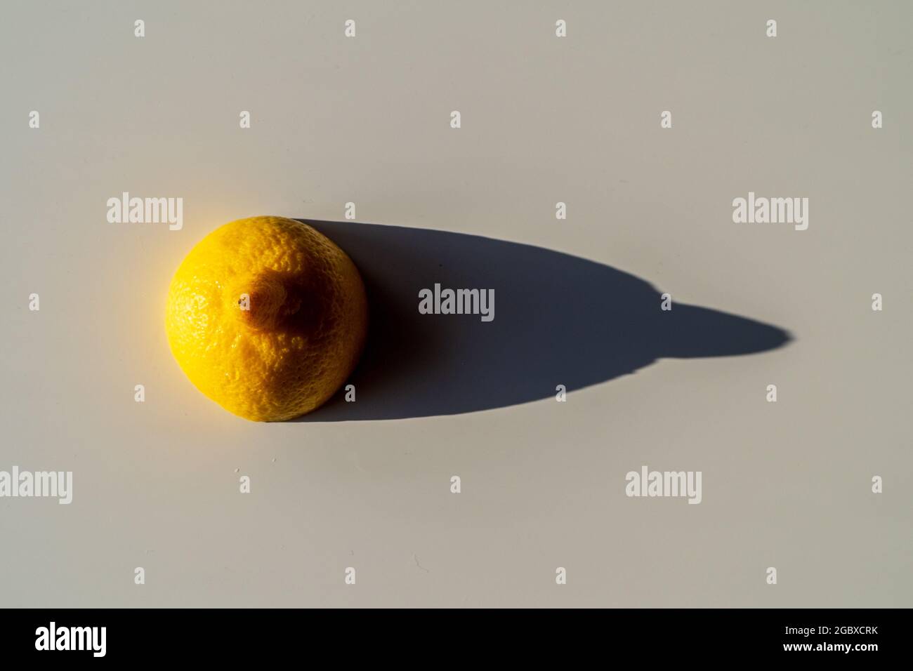Half a lemon and its shadow on a white background Stock Photo - Alamy