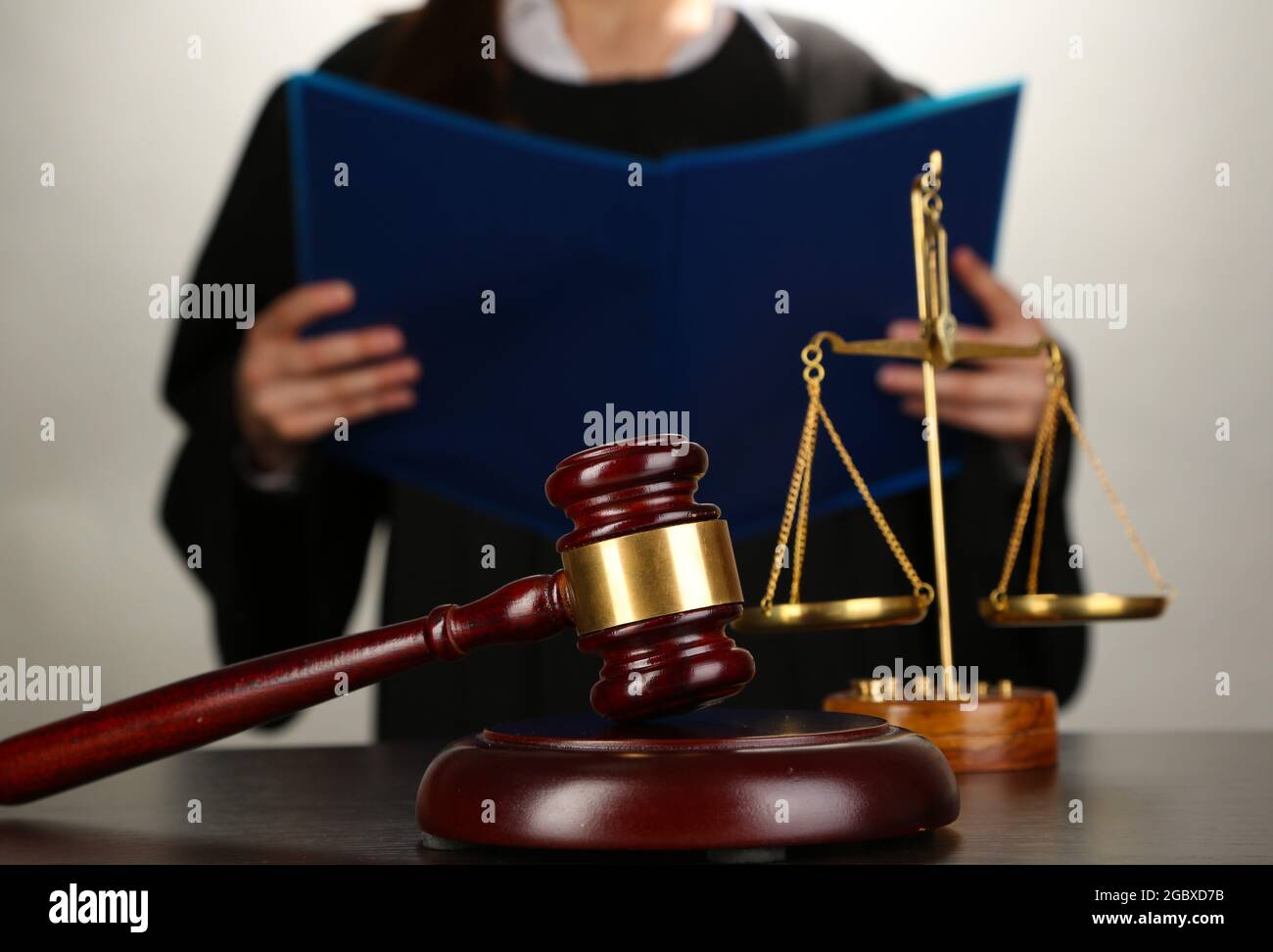 Judge read verdict on grey background Stock Photo - Alamy
