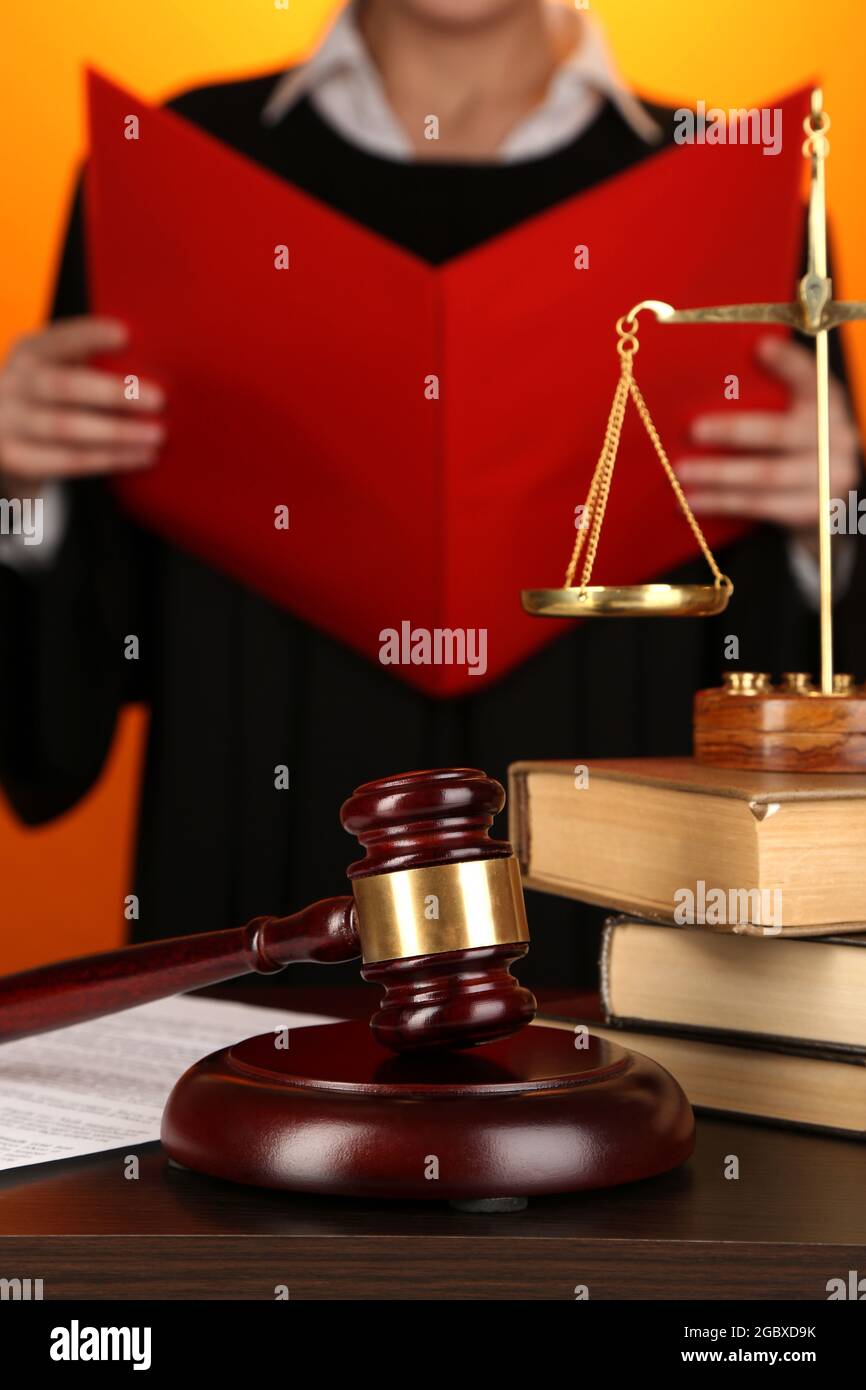Judge read verdict on orange background Stock Photo - Alamy