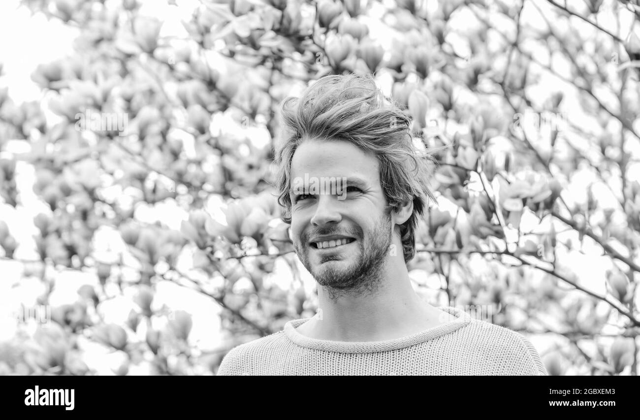 Joy of spring. Man flowers background. Spring beauty. Hipster enjoy ...