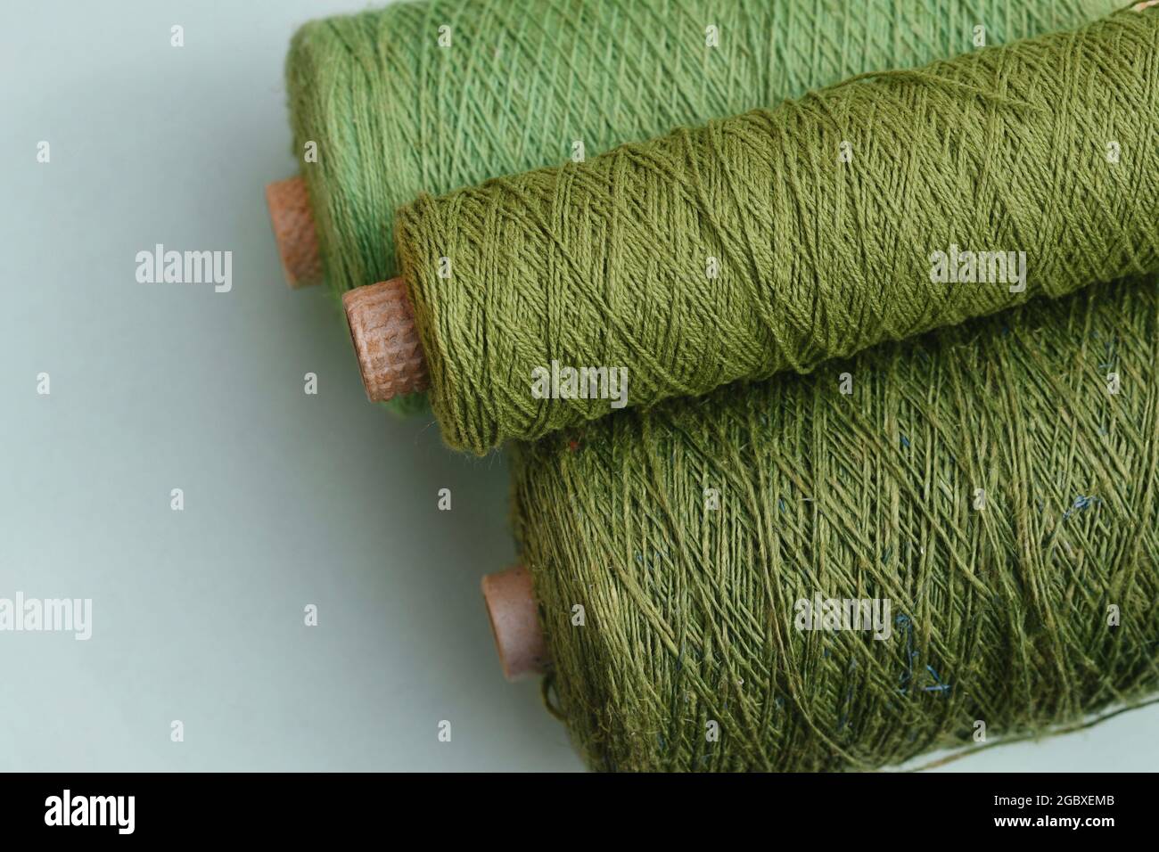 Photo of threads in different shades of green on bright background ...