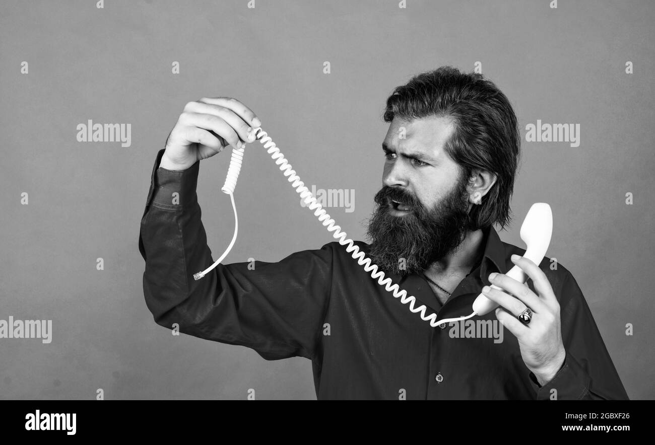 mature male hold broken retro phone. guy with beard and moustache ...