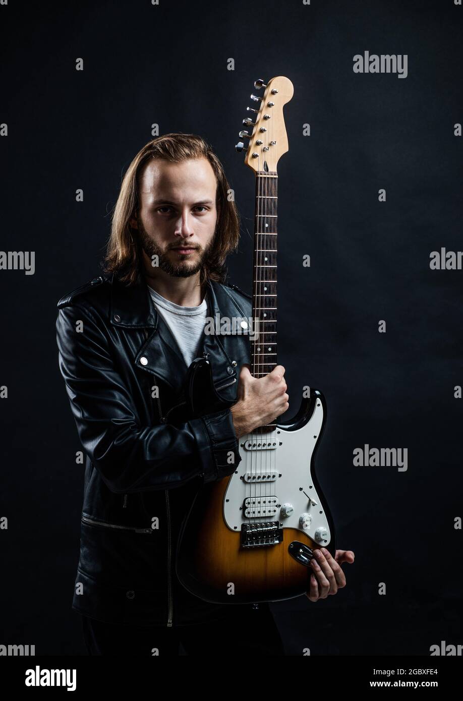 presenting product. string musical instrument. bearded rocker Stock ...