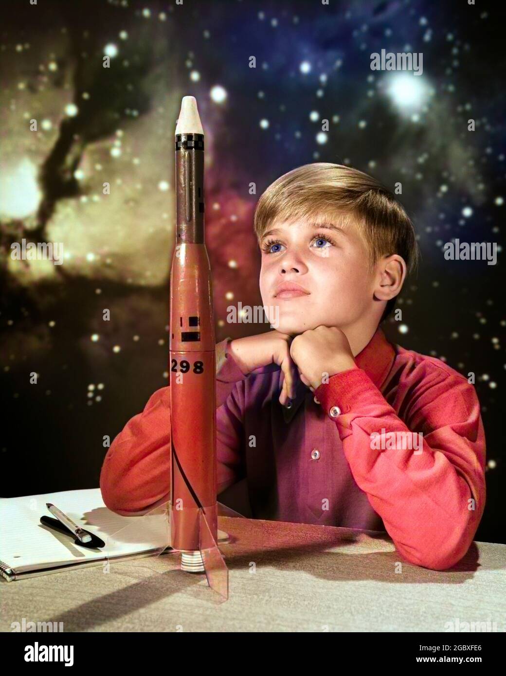 1960s DAY DREAMING BOY WITH MODEL ROCKET AND OUTER SPACE BACKGROUND ...
