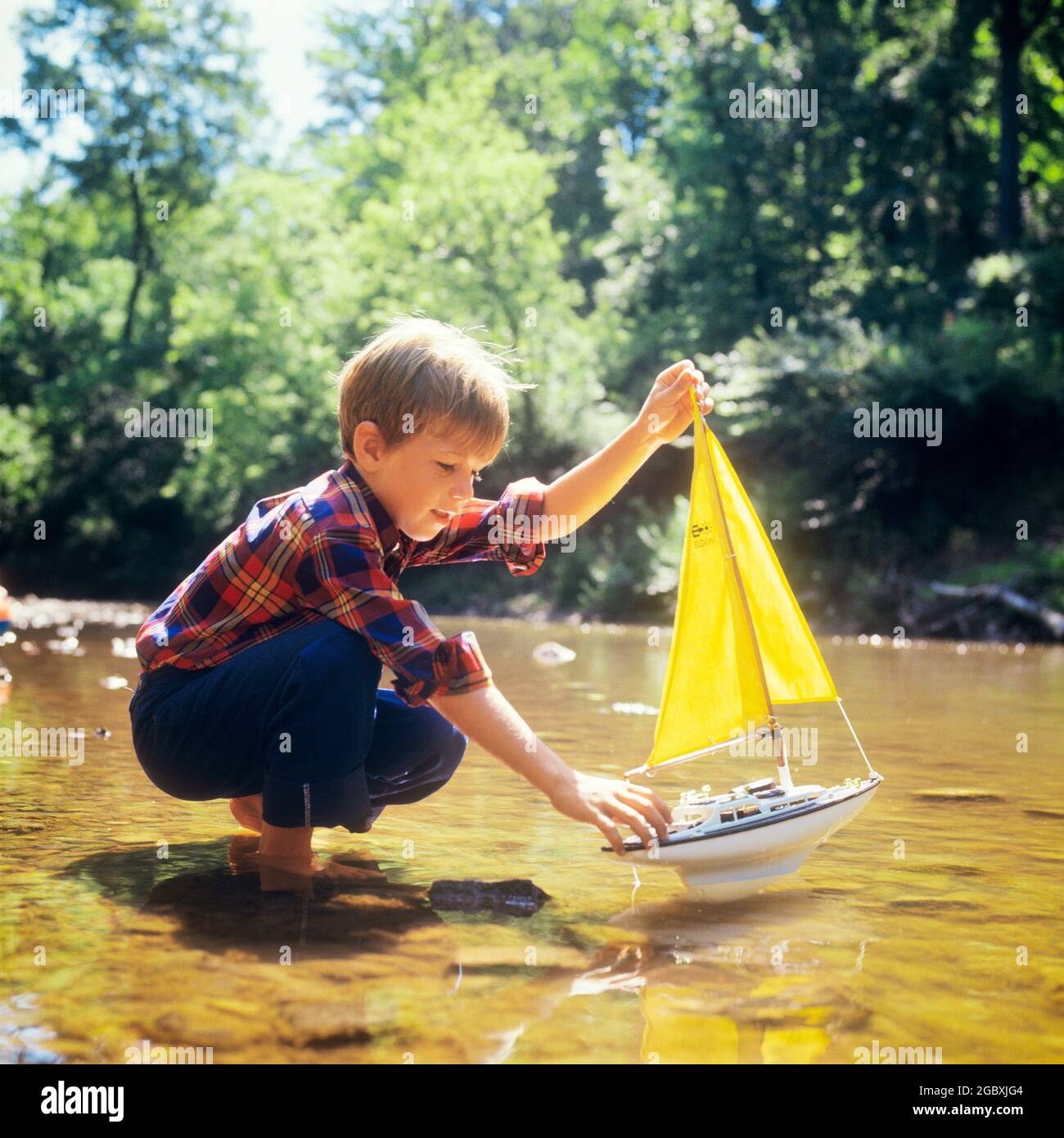 Boys with toy boat hi-res stock photography and images - Alamy