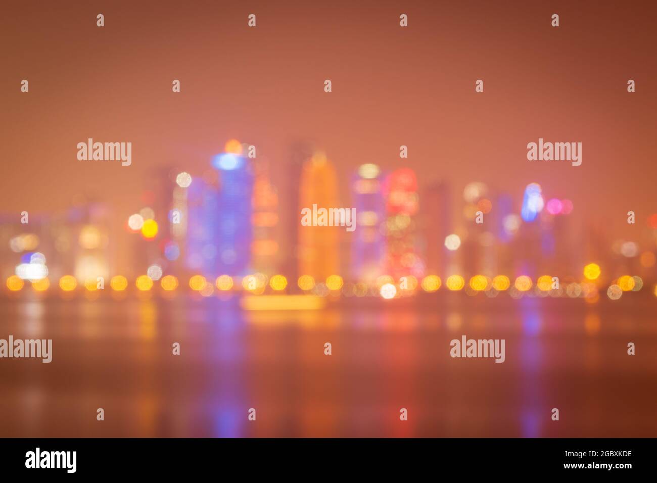 Blurred colorful lights from illuminated skyline of Doha at night ...