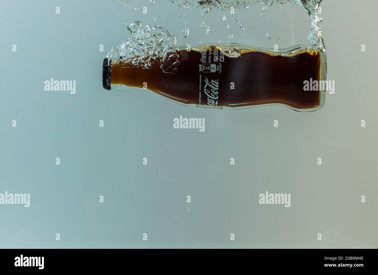 Close up view of Coca cola bottle falling in water Stock Photo - Alamy