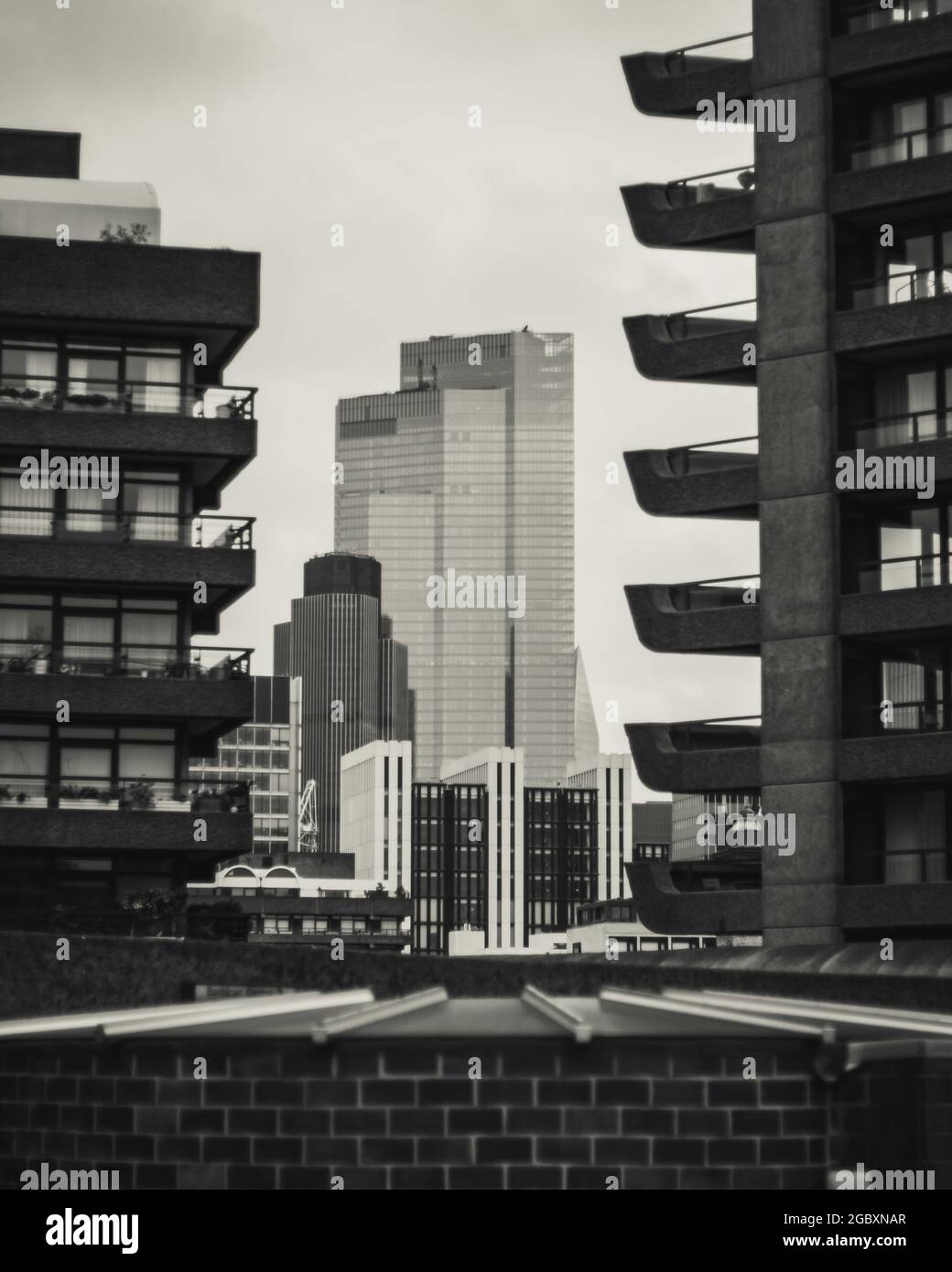Vertical shot of modern buildings in the daylight shot in dim colors ...