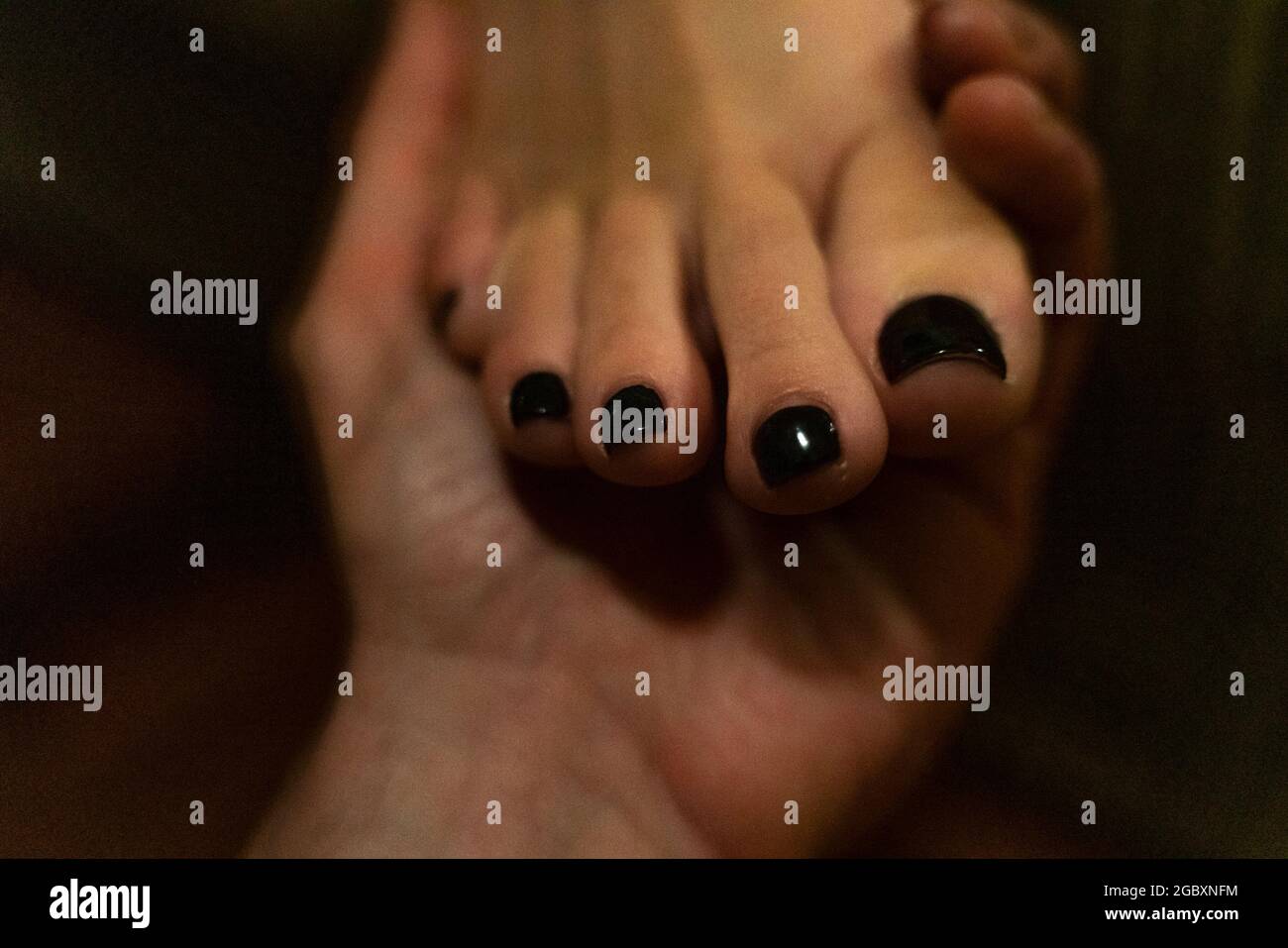 Foot In Hand Stock Photo - Alamy