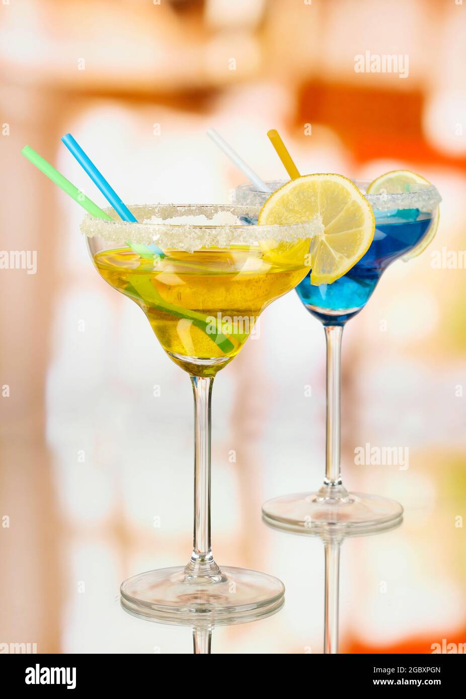 Yellow and blue cocktails in glasses on room background Stock Photo - Alamy