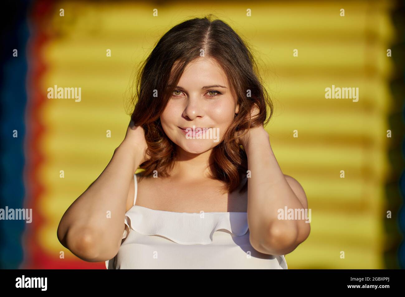 Portrait of young woman 26 years old on bright yellow background Stock ...