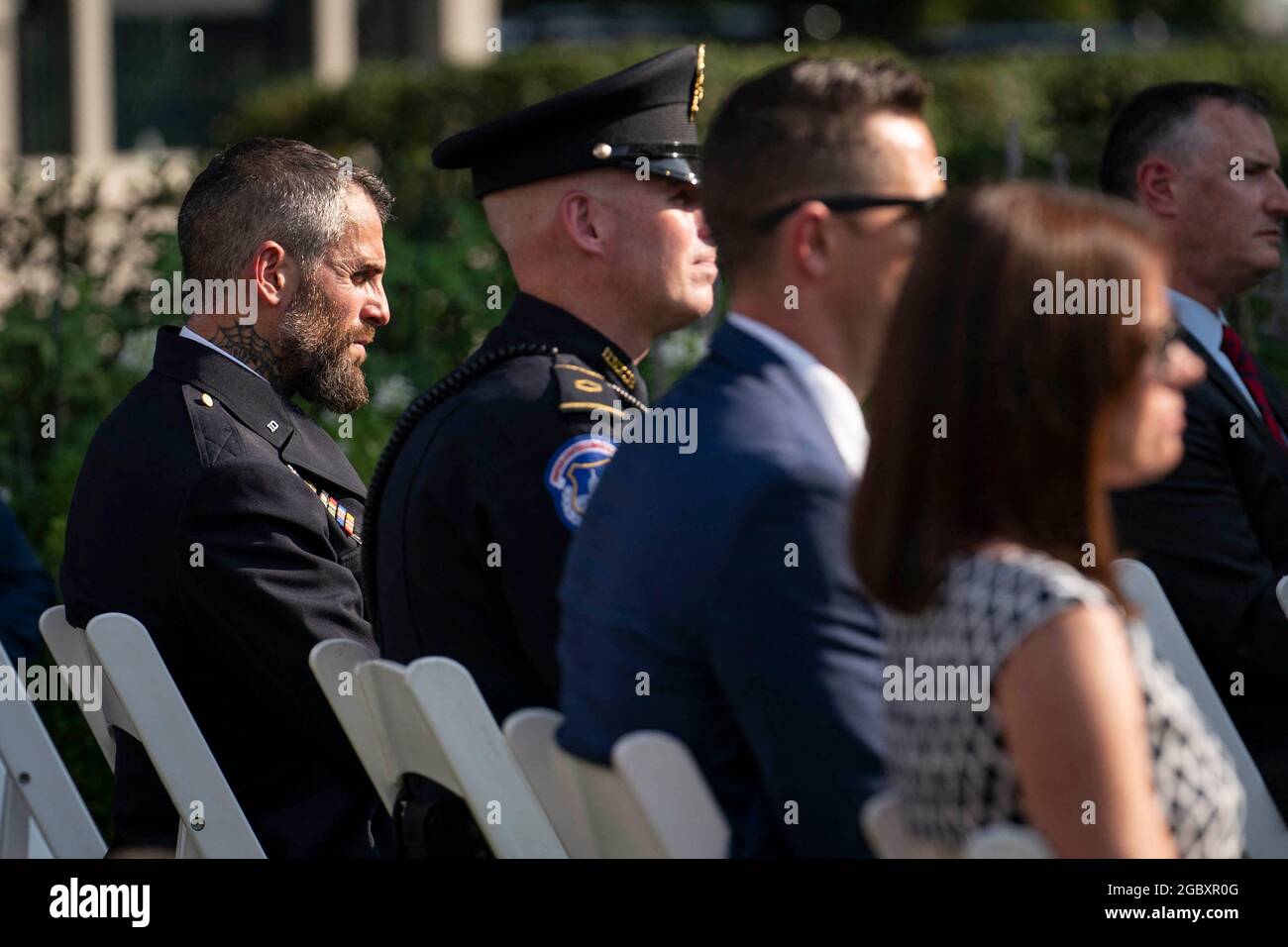 US Capitol Police Officer Michael Fanone listens as President Joe Biden ...