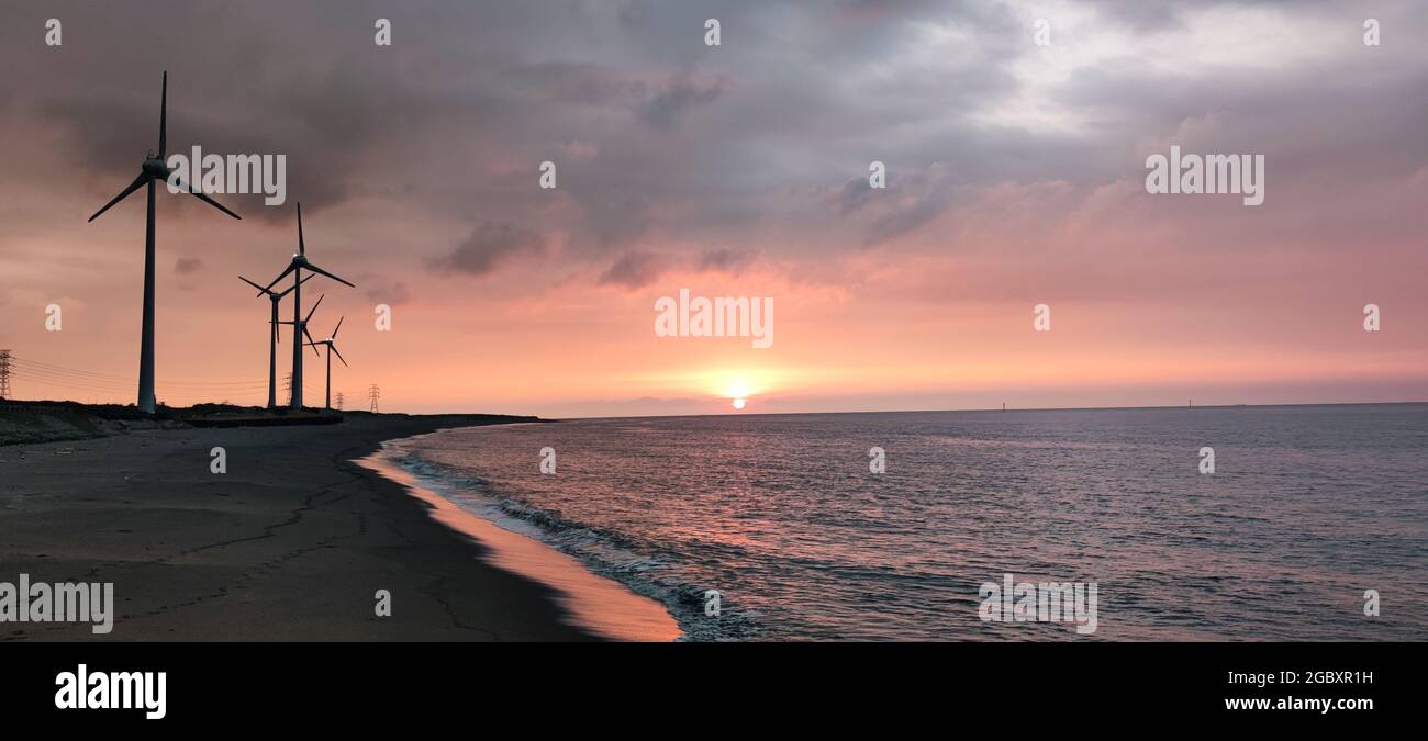 The sillouette of Wind turbine array at seashore Stock Photo - Alamy