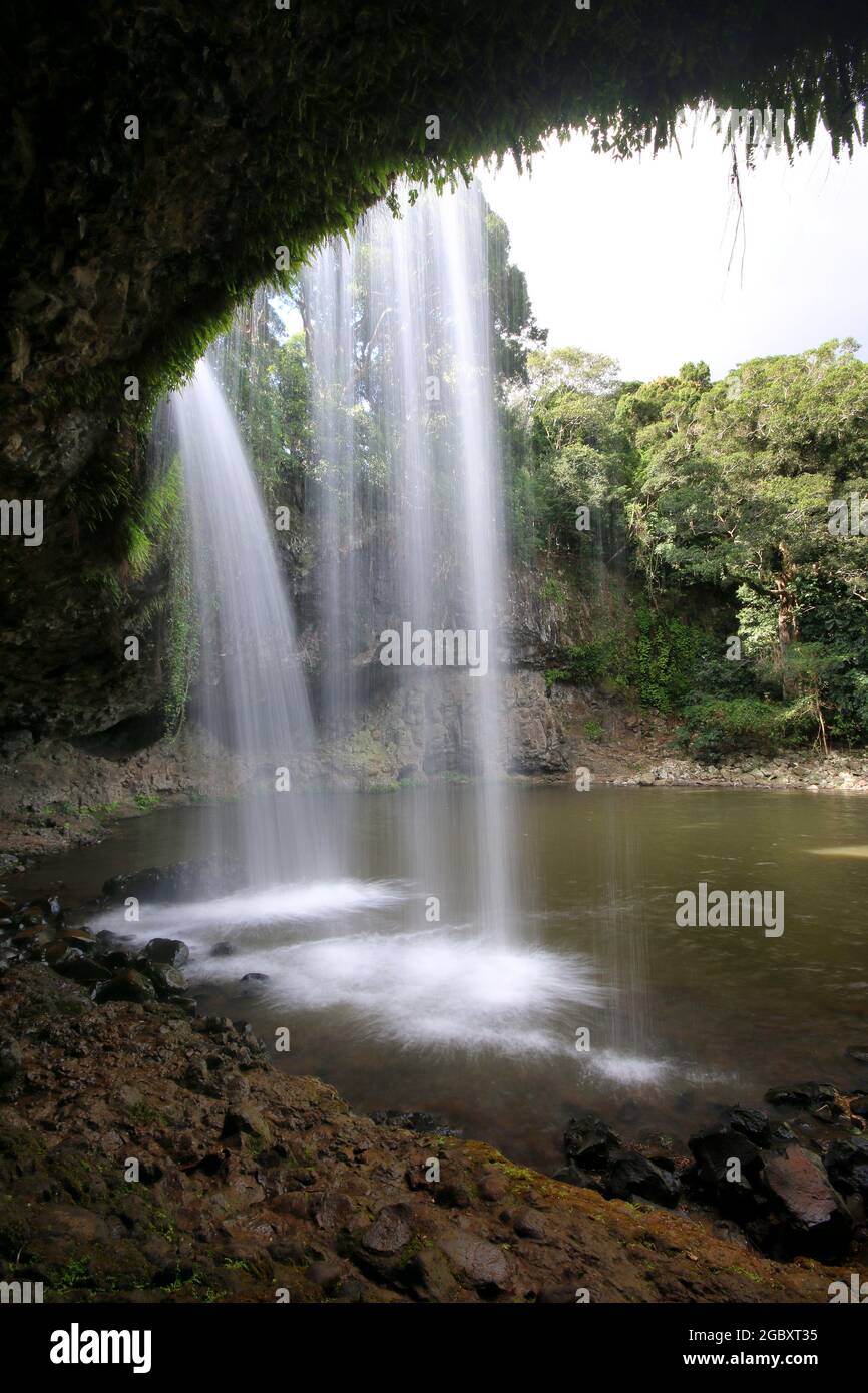a waterfall going over a body of water Stock Photo - Alamy
