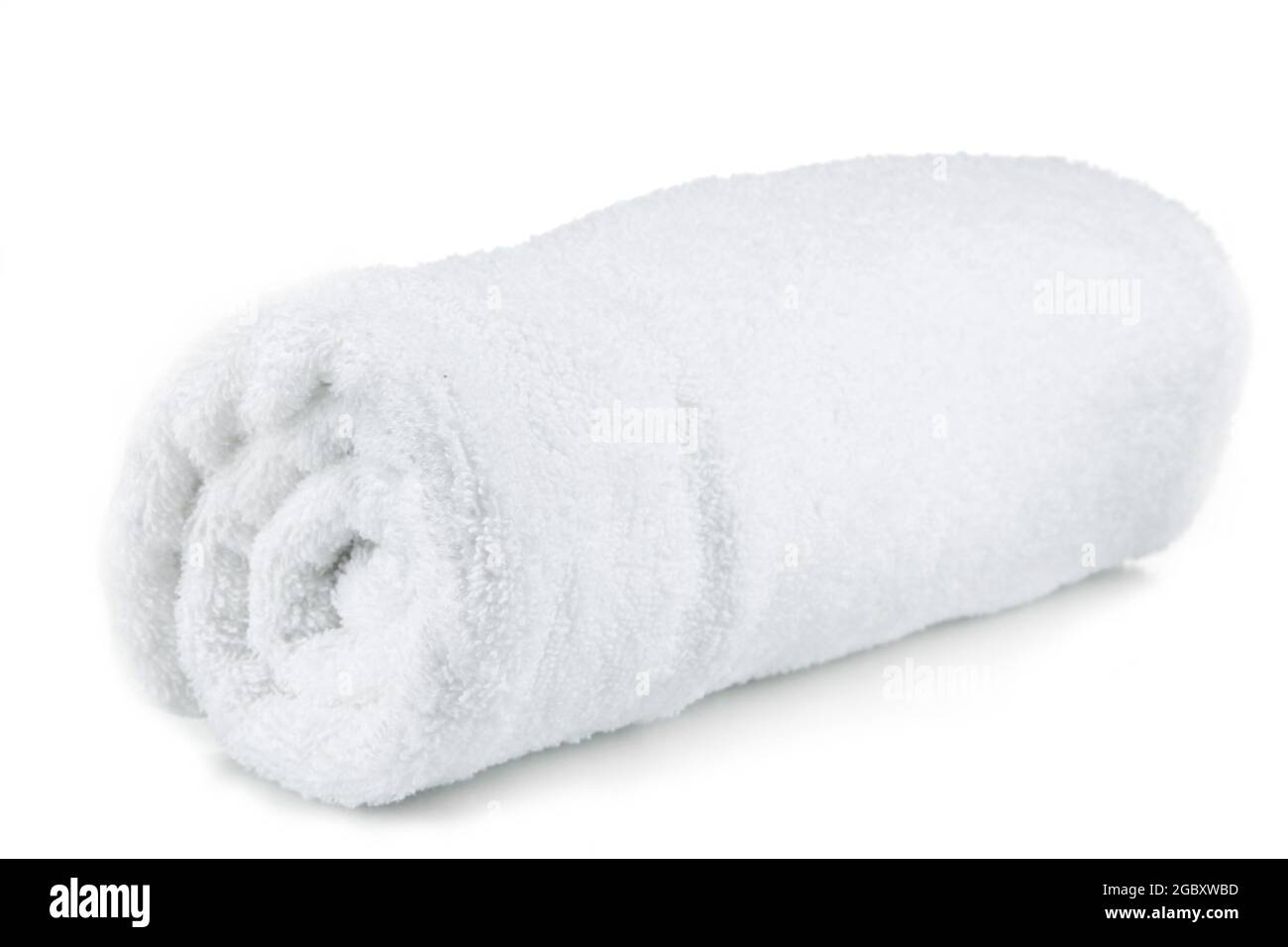 Rolled up white towel isolated on white Stock Photo - Alamy