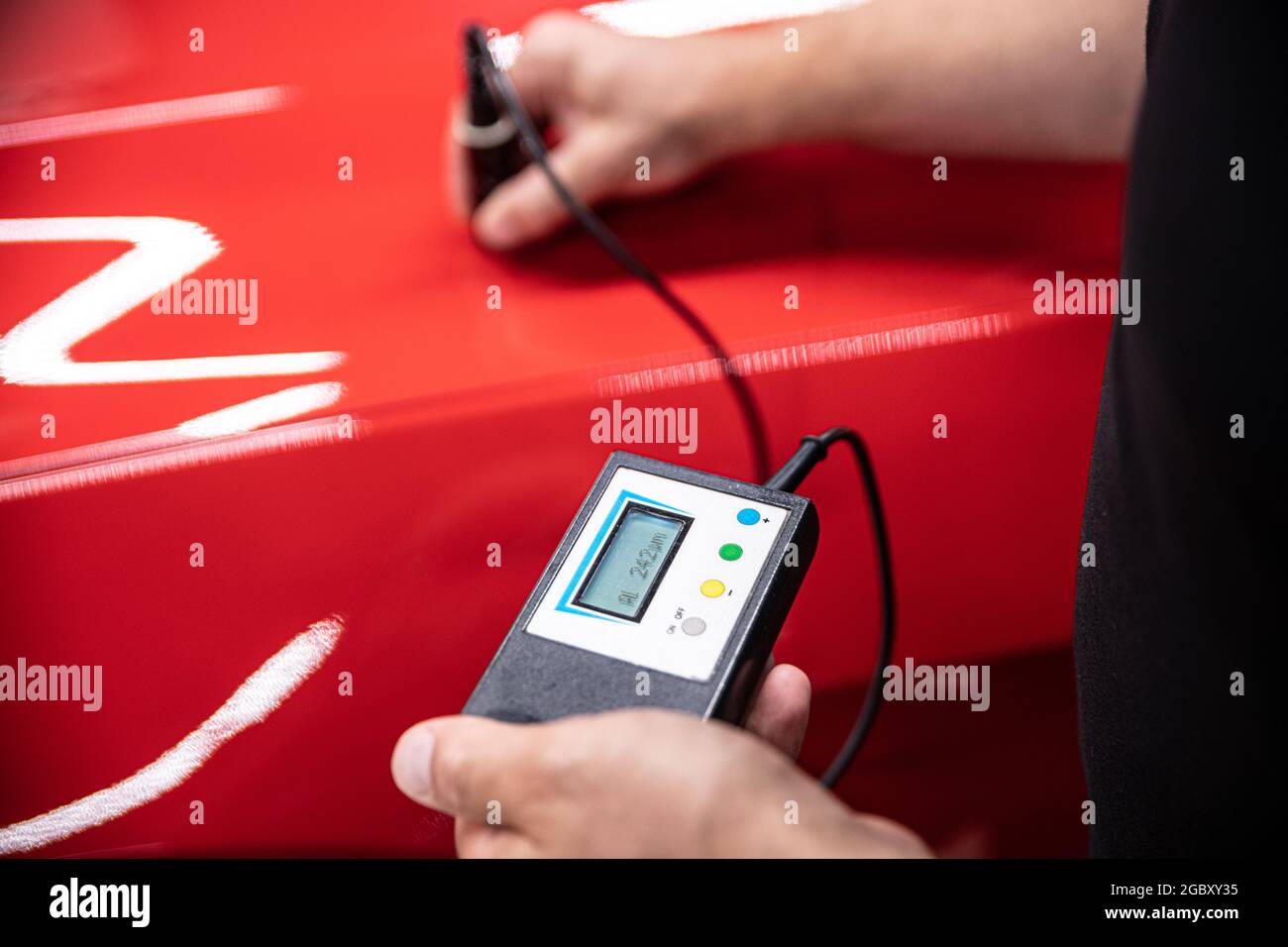 Man mechanic checking car paint thickness with electronic meter Stock ...