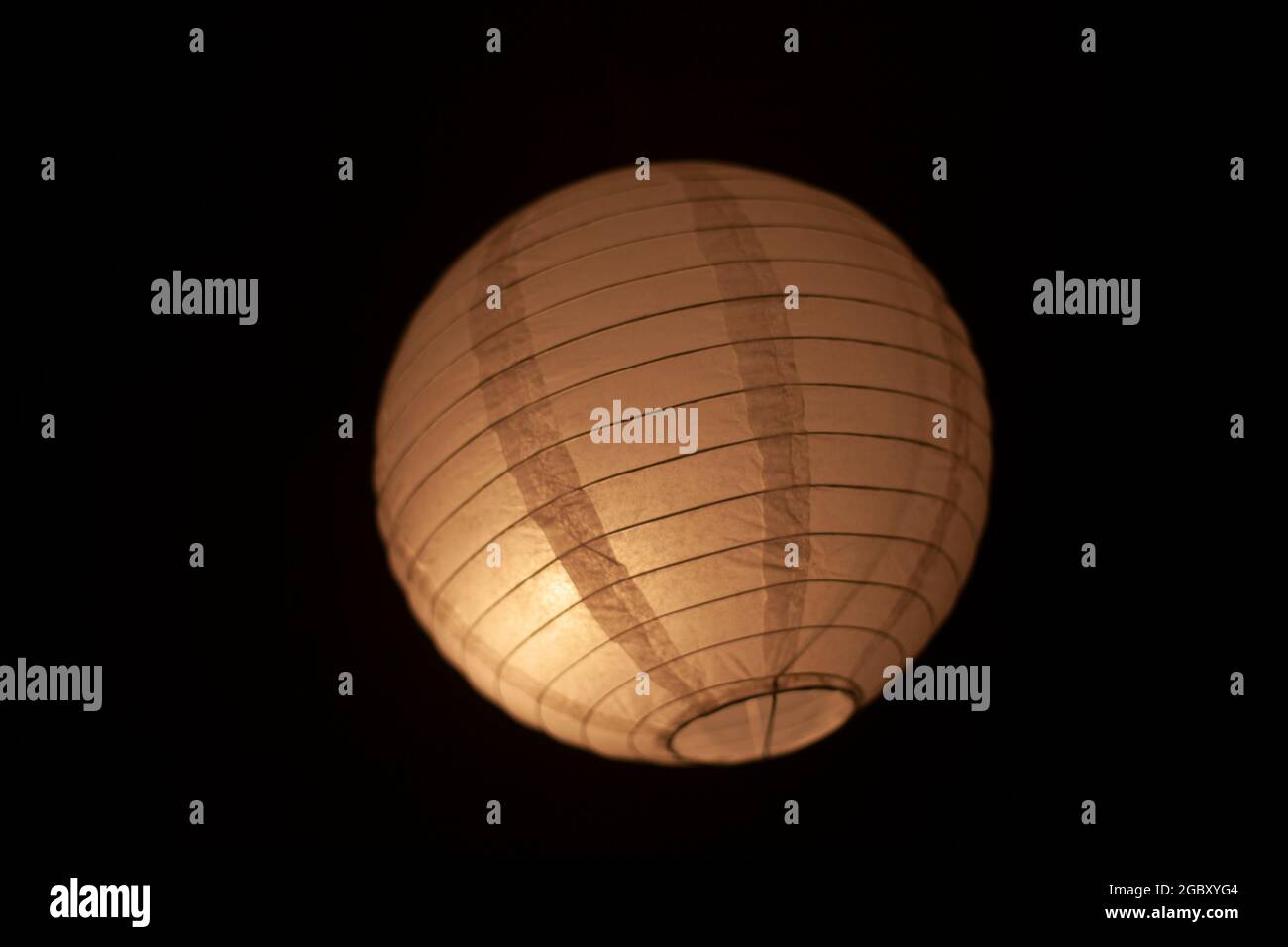 Chinese lamp on a black background. The lamp is in the traditional ...