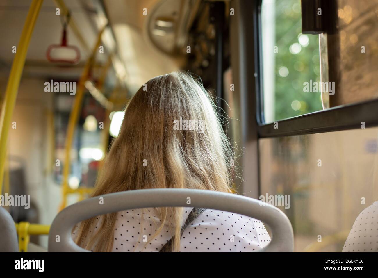 Passenger on the bus. The girl in public transport. The girl sits on a ...