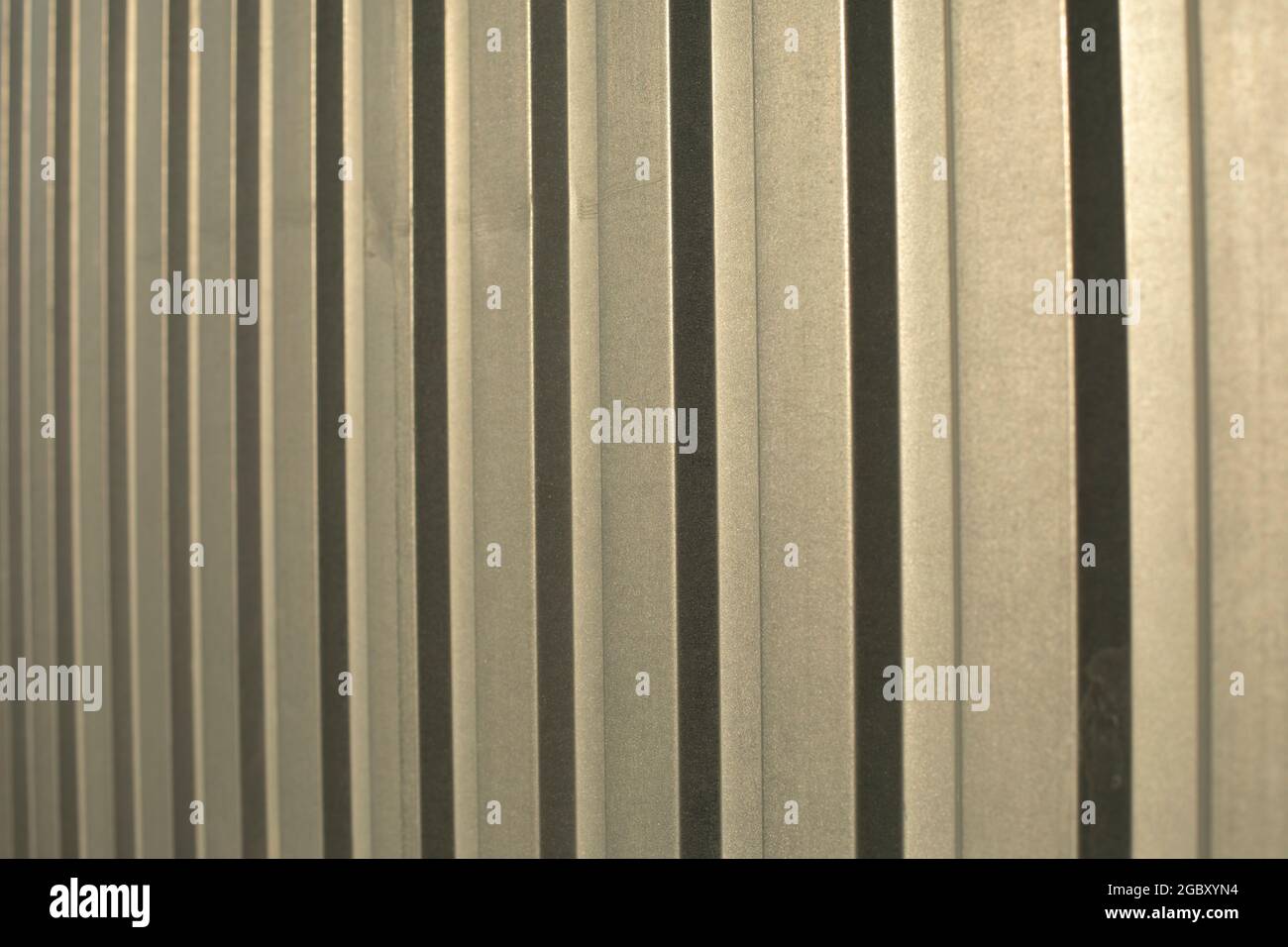 The texture of the metal fence. Stainless steel in sunlight. Simple ...