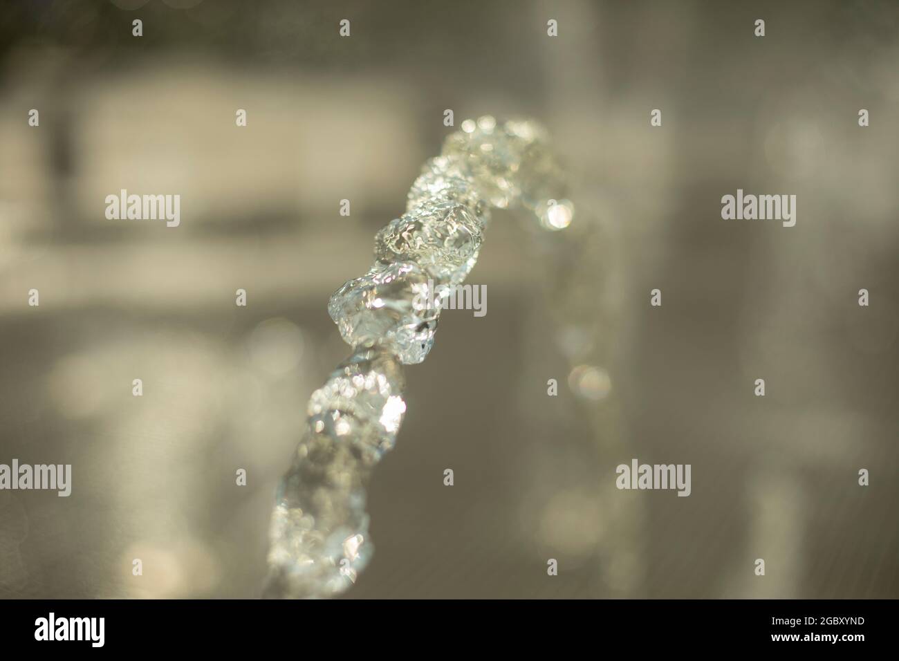 Splashing water. A jet of liquid. Water in natural light. Fountain jet ...