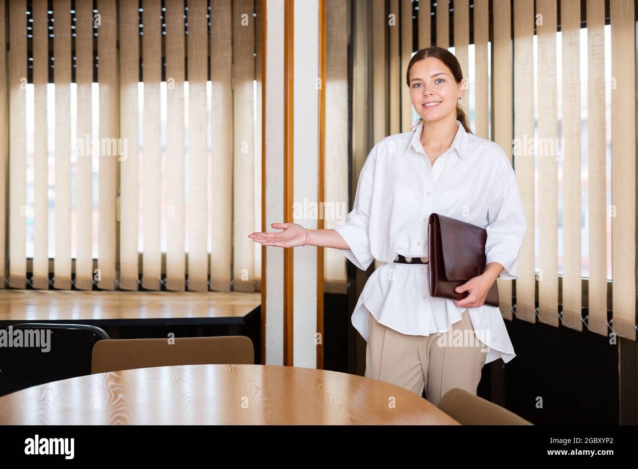 successful businessman invites you to the office Stock Photo - Alamy