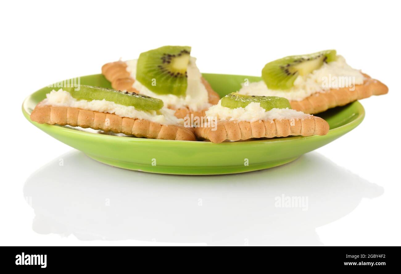 Canapes with cheese and kiwi, on color plate, isolated on white Stock ...
