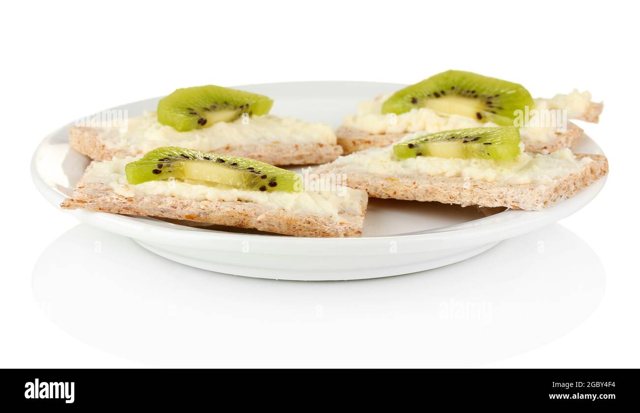 Canapes with cheese and kiwi, on color plate, isolated on white Stock ...