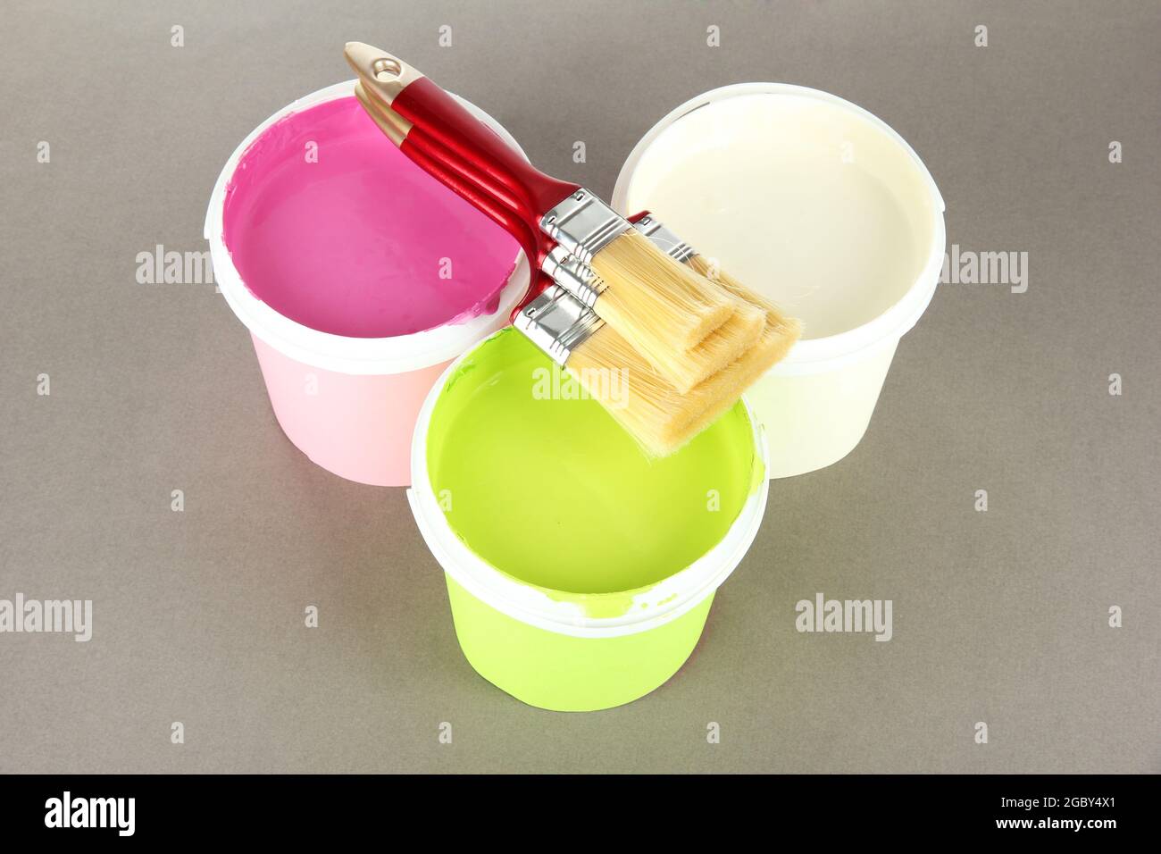 Set for painting: paint pot, brushes on grey background Stock Photo - Alamy