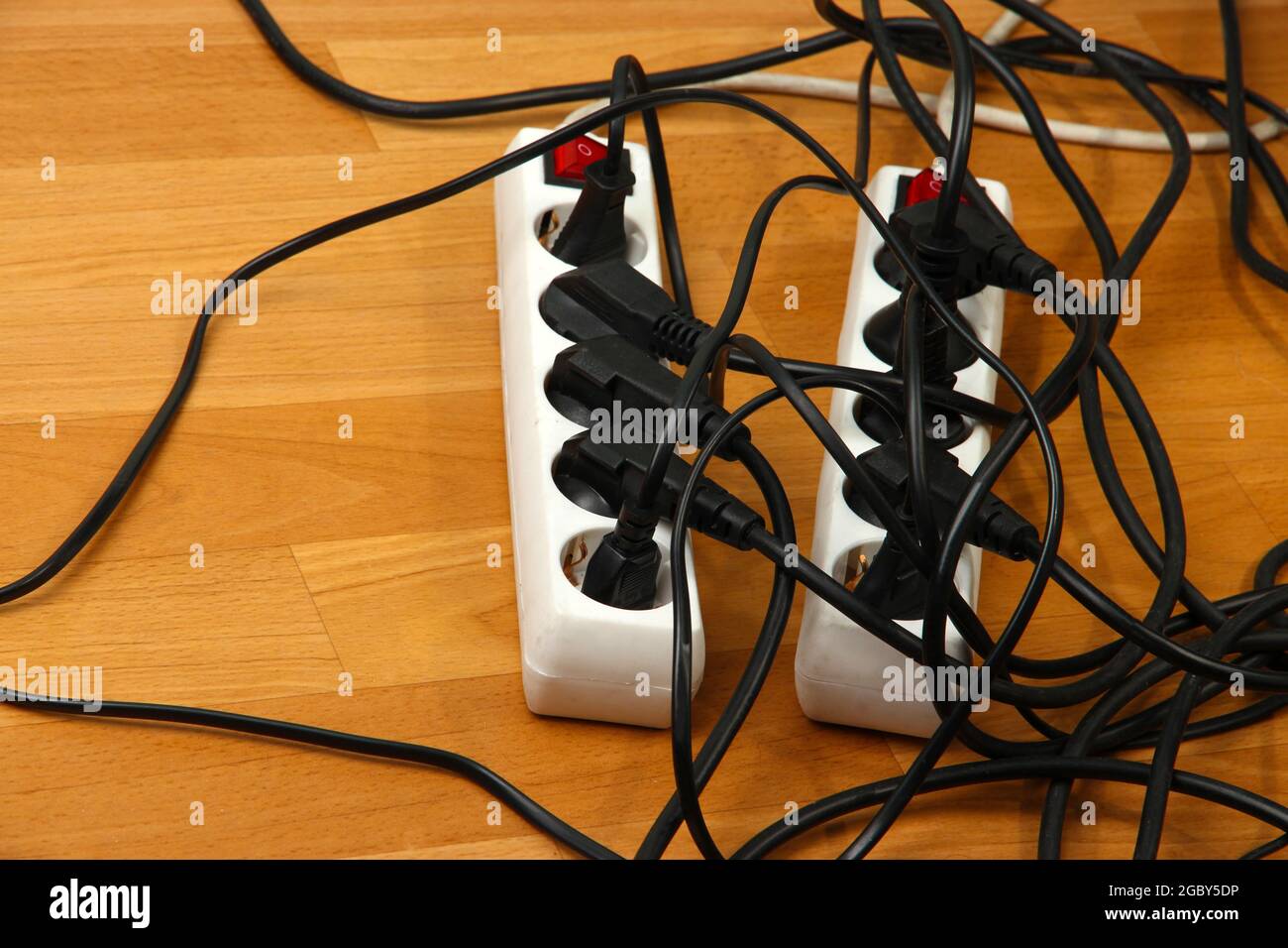 Overloaded power boards, close up Stock Photo - Alamy