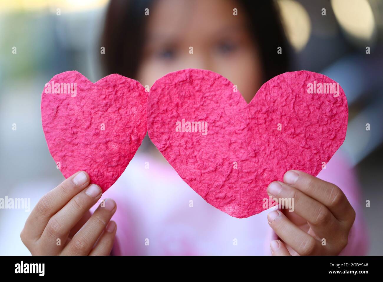 Show red empty heart shape on the child's hand for Concept of love and ...