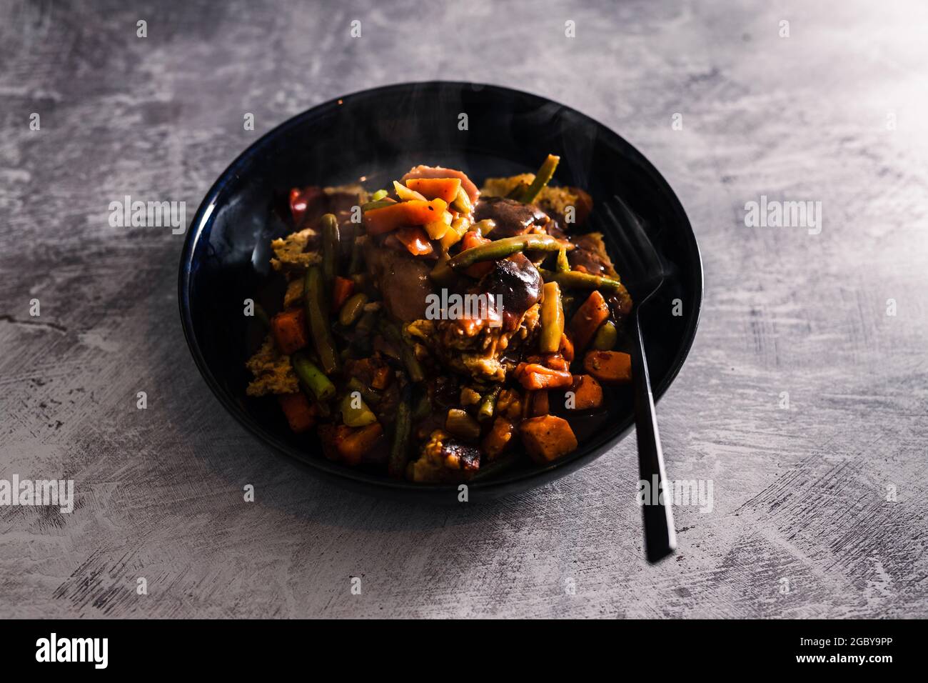 vegan roast with mixed vegetables and plant-based meatloaf slices ...