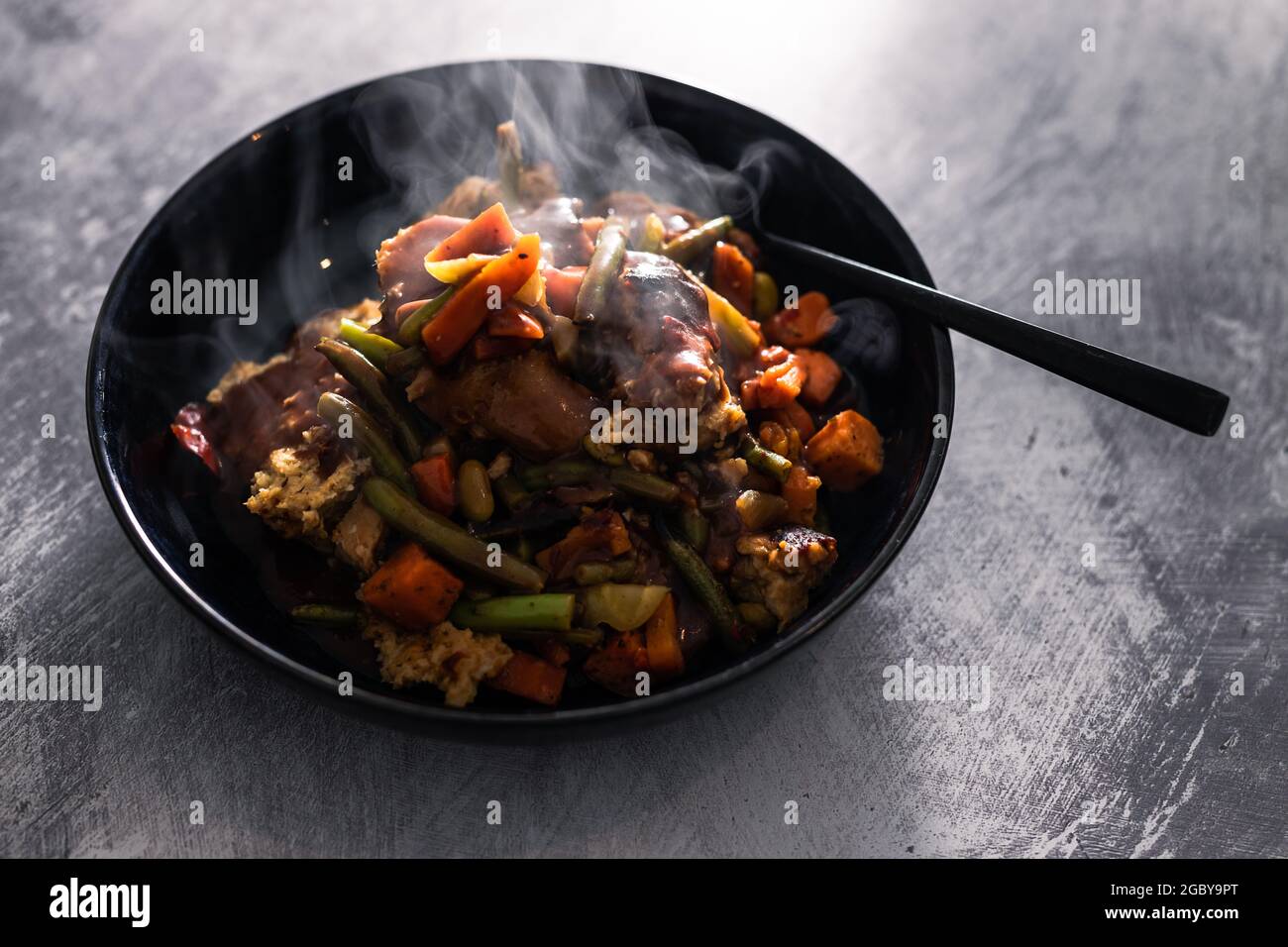 vegan roast with mixed vegetables and plant-based meatloaf slices ...