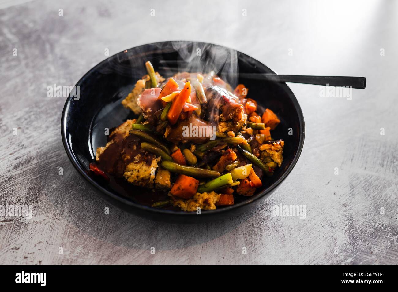vegan roast with mixed vegetables and plant-based meatloaf slices ...