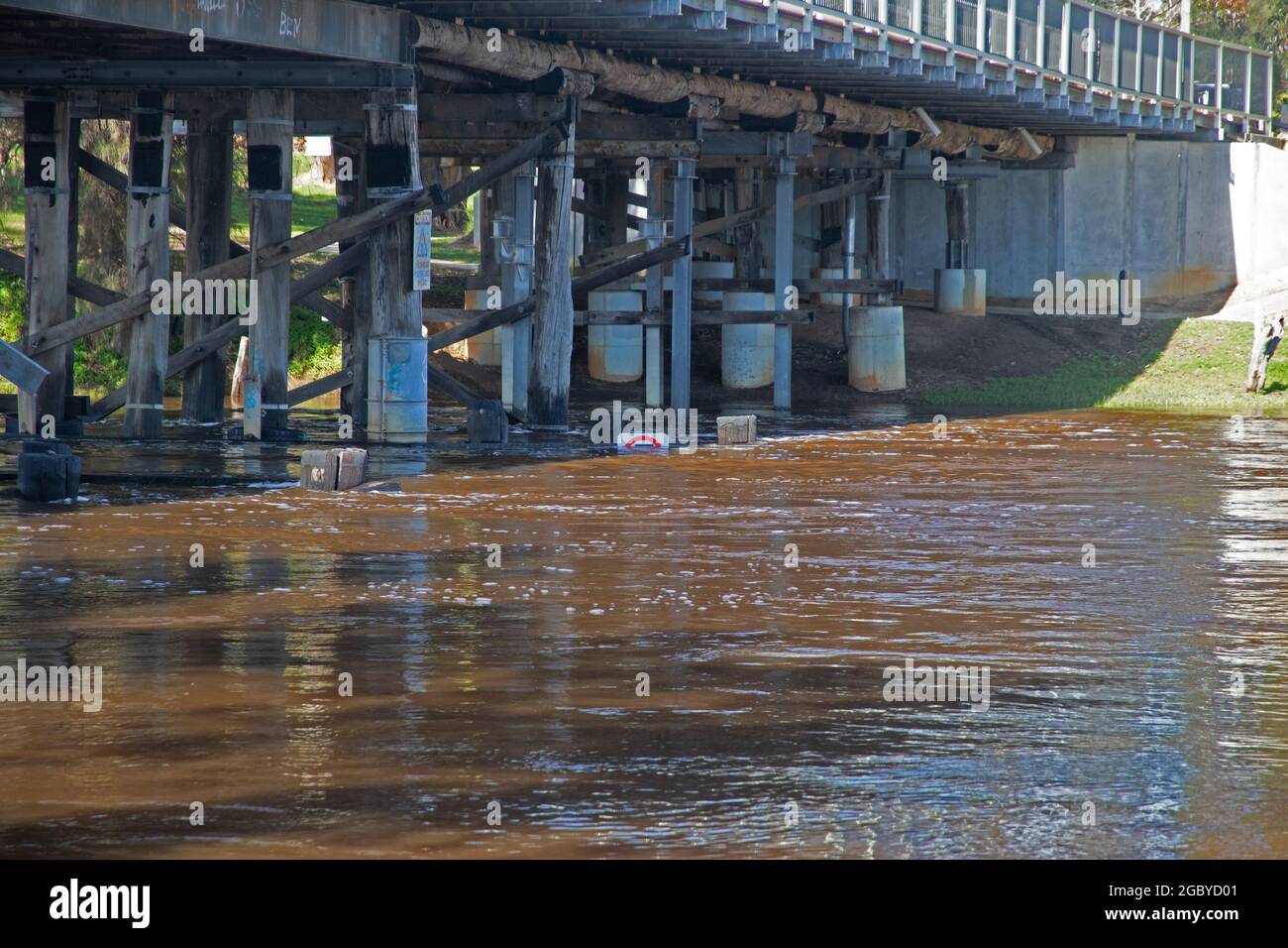 Old bridge spanning river in flood Stock Photo - Alamy