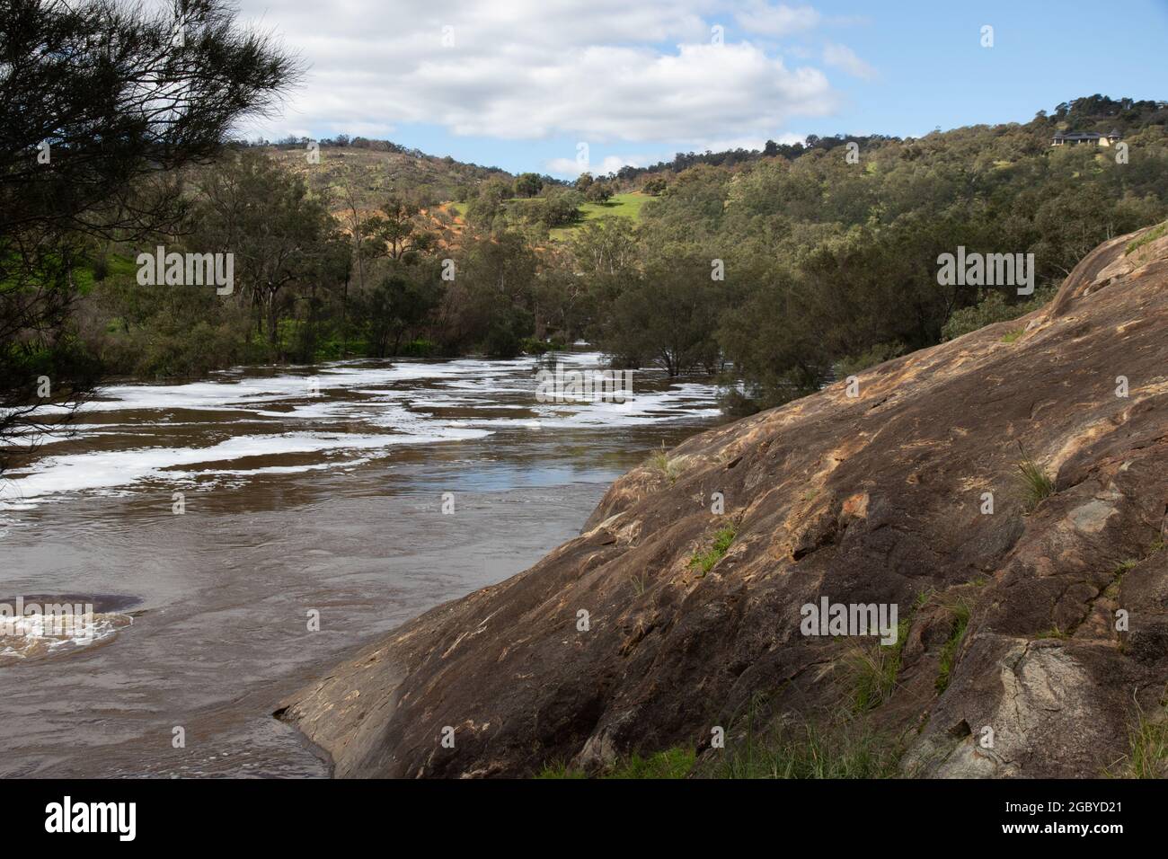 Fast moving river flows past rocky outcrop Stock Photo - Alamy