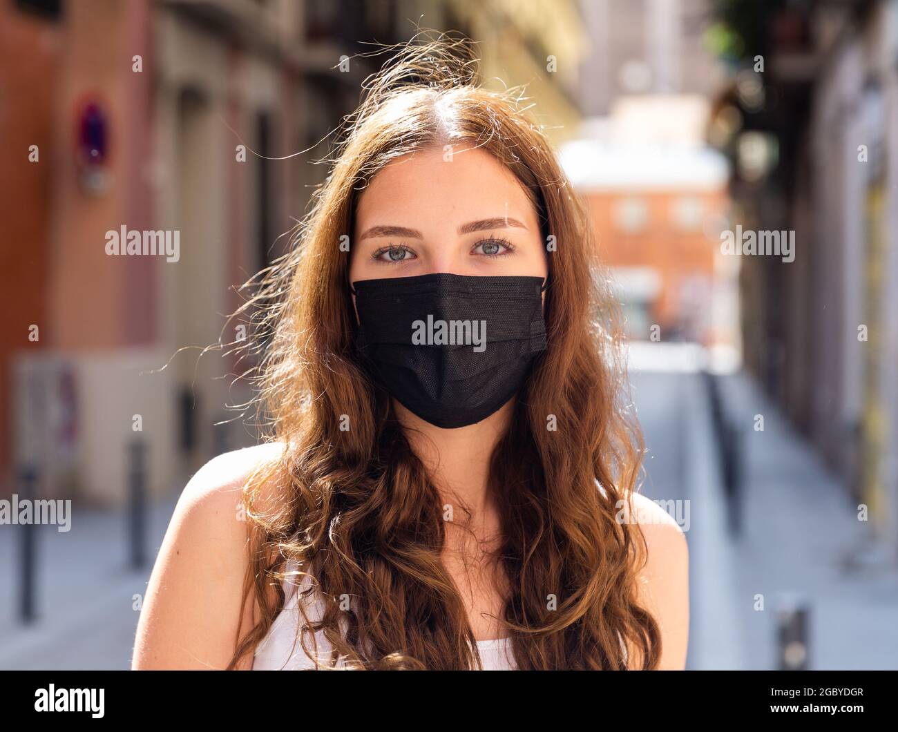 Woman wearing disposable face mask walking on street closeup Stock ...