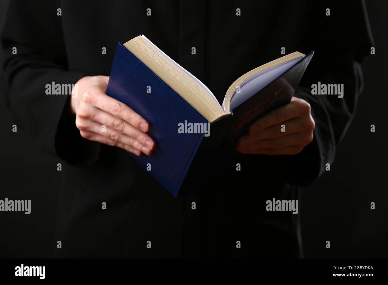 Priest reading from the holy bible, close up Stock Photo - Alamy