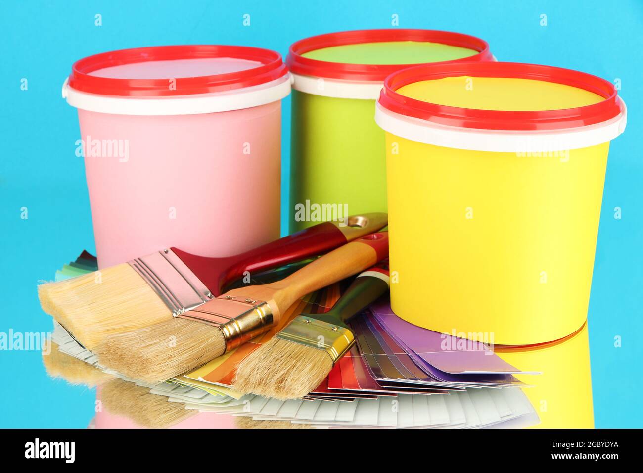 Set for painting: paint pots, brushes, palette of colors on blue ...