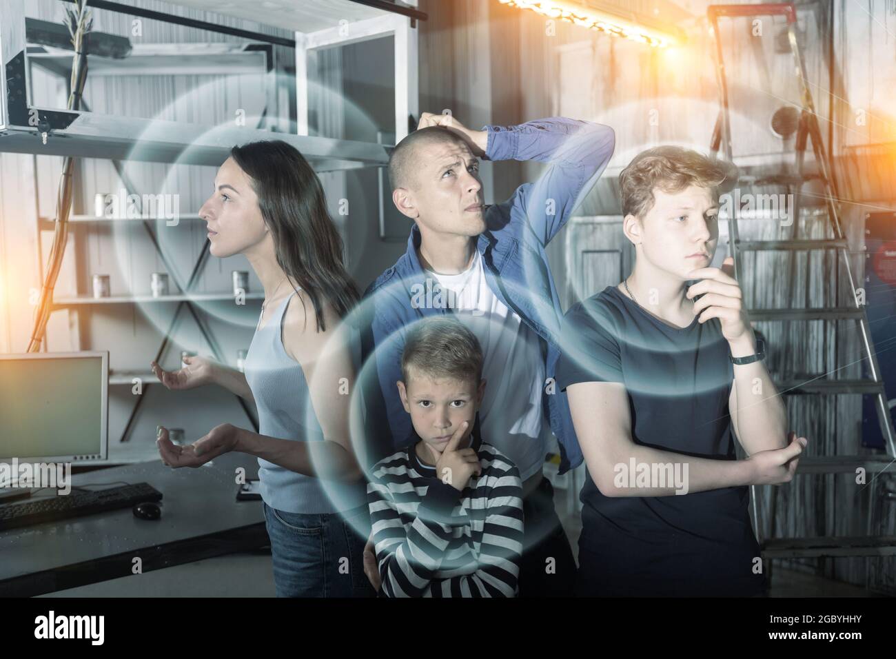 Family solving conundrums in quest room stylized as bunker Stock Photo ...
