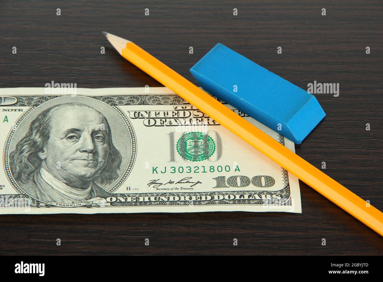 Making fake dollar on wooden background Stock Photo - Alamy