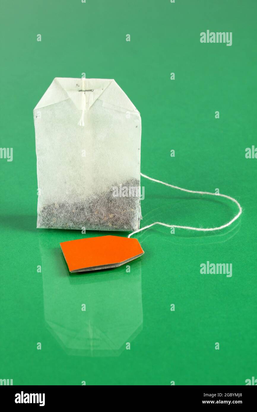 Tea bag on green background Stock Photo - Alamy