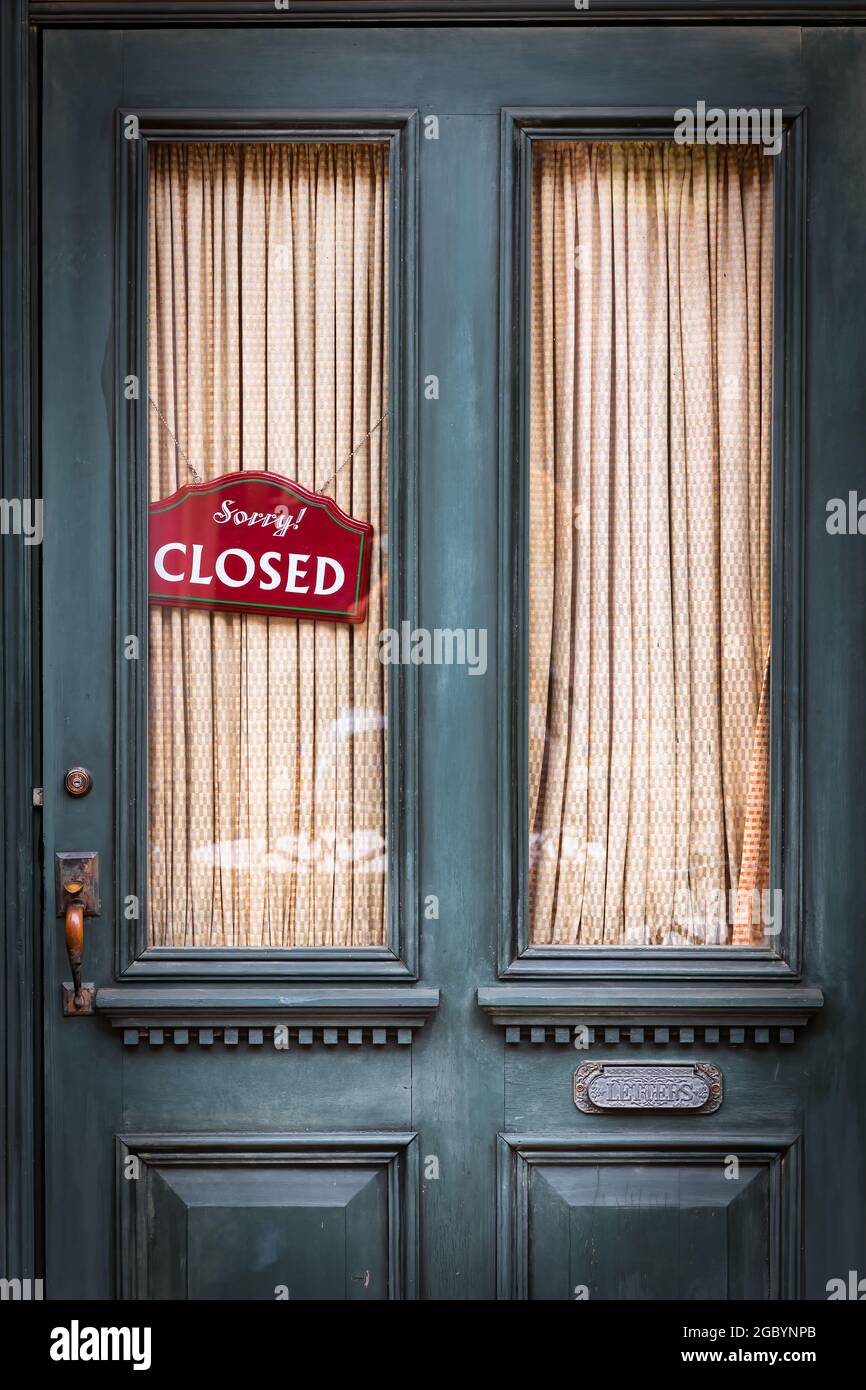 A closed sign hangs in an old retro door window in Osaka, Japan Stock ...