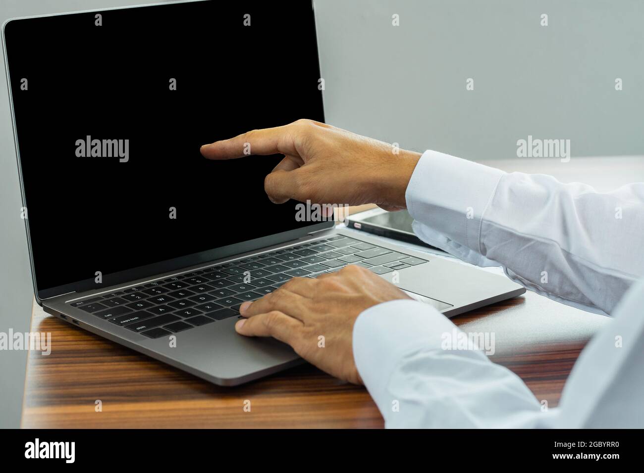 Businessman using computer in office, Hand touch on screen monitor ...