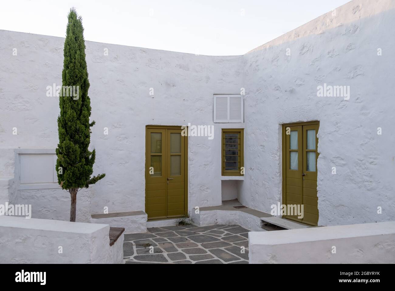 Cyclades Greece. Milos island, Plaka Chora, Cobblestone yard, cypress ...