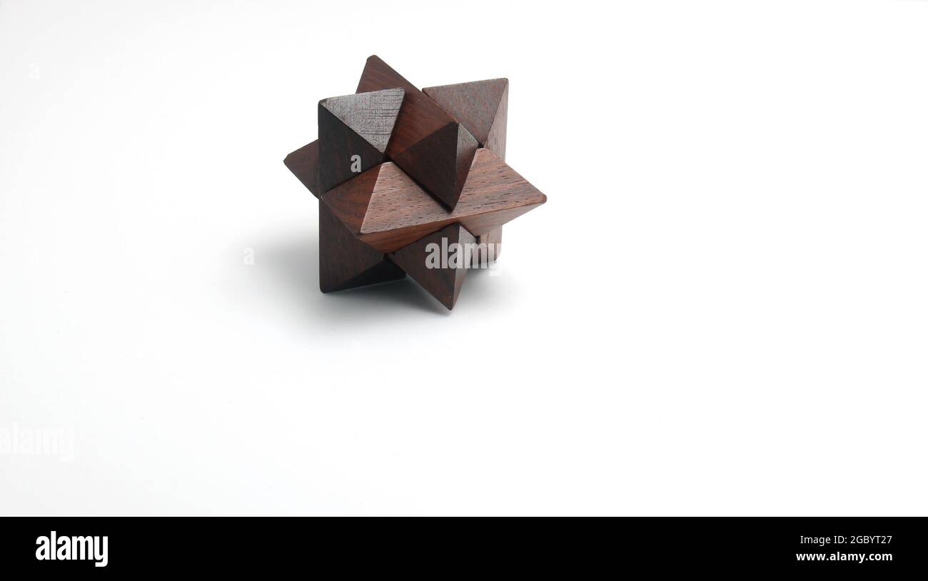 Complex wooden puzzle with white space for copy Stock Photo - Alamy